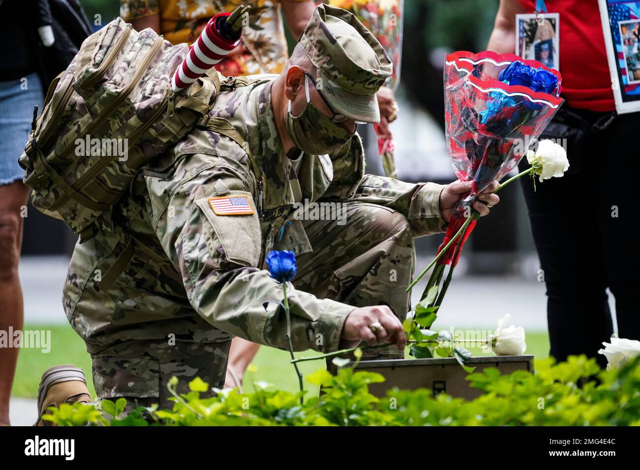 US Army Sgt. Edwin Morales places flowers for fallen FDNY firefighter ...