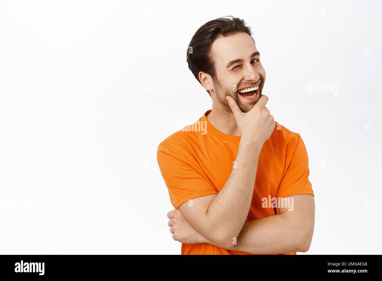 Image of charming brunette man with beard, winking and smiling at ...