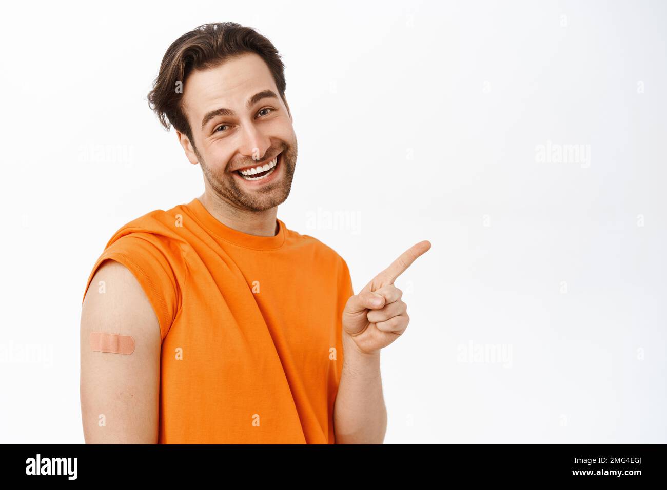 Handsome young man with band aid on shoulder, pointing finger at logo ...