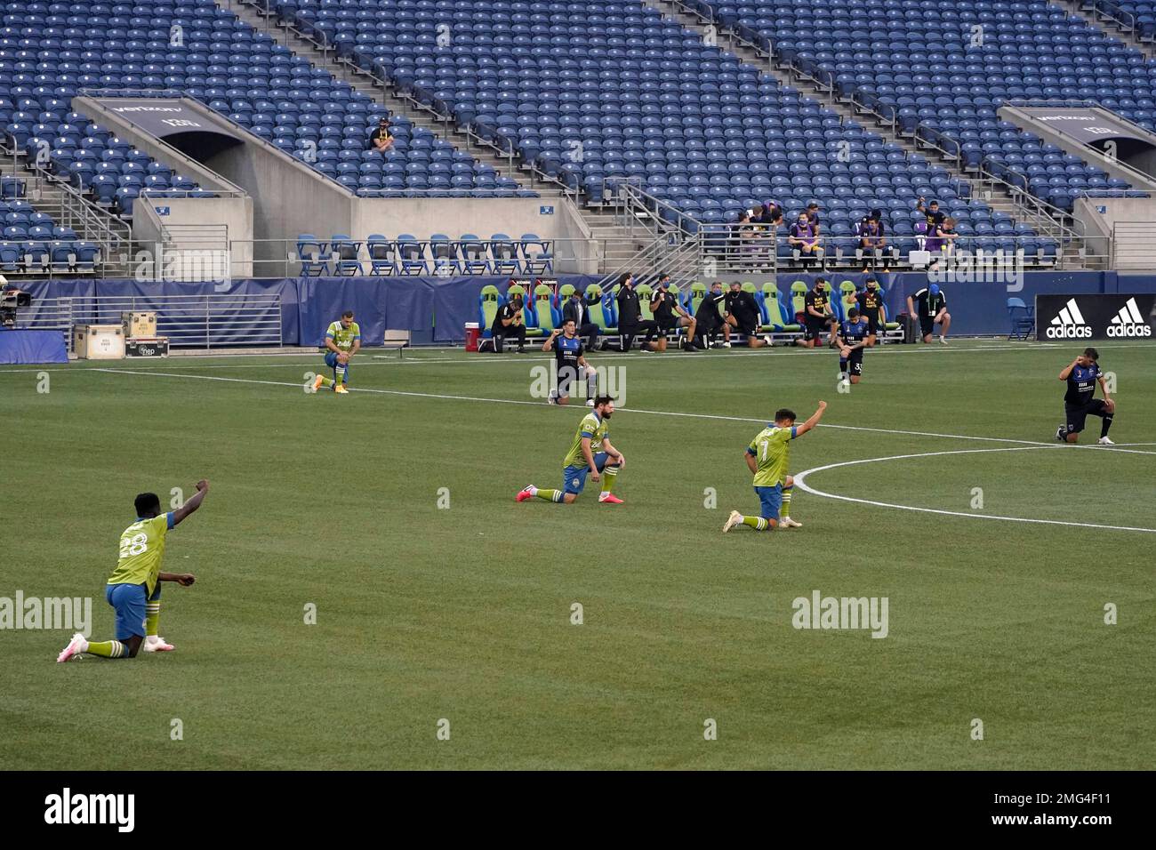 Seattle Sounders and San Jose Earthquakes players kneel and raise fists ...