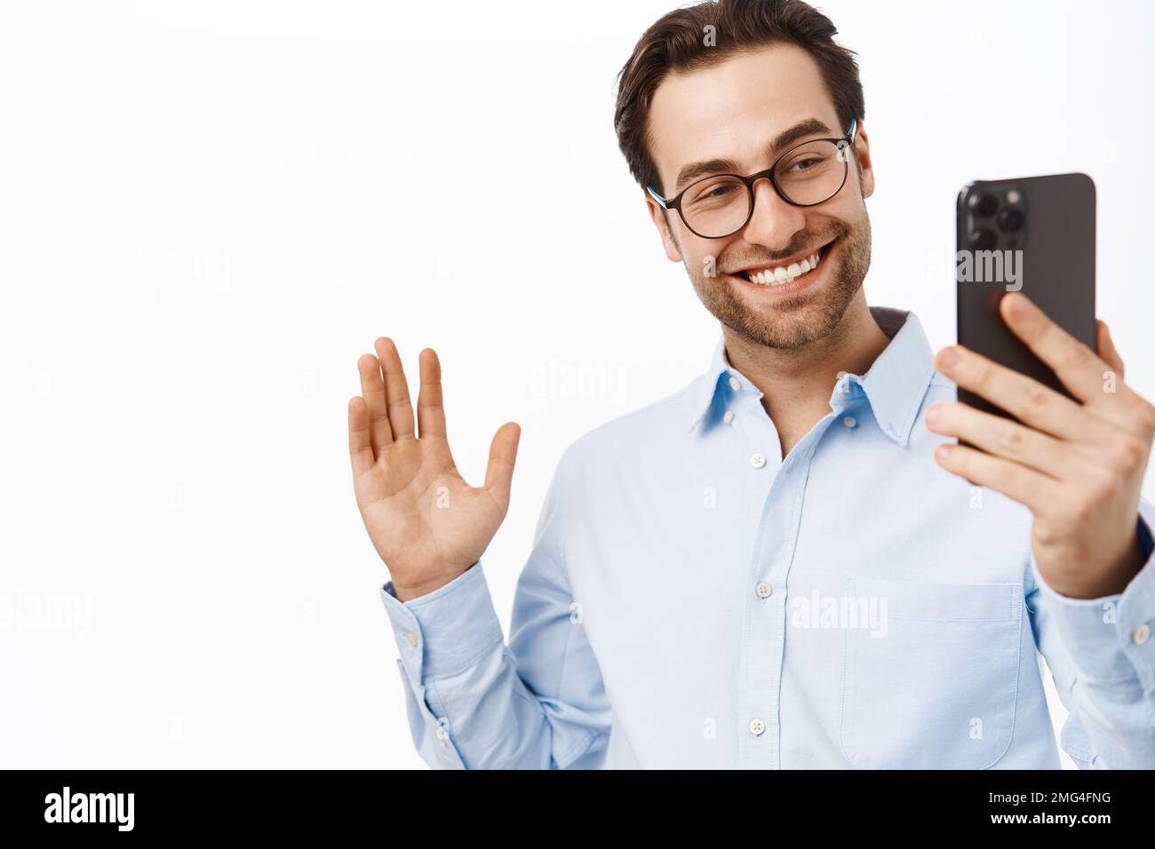 Handsome businessman demonstrating smth on video call. Office worker ...