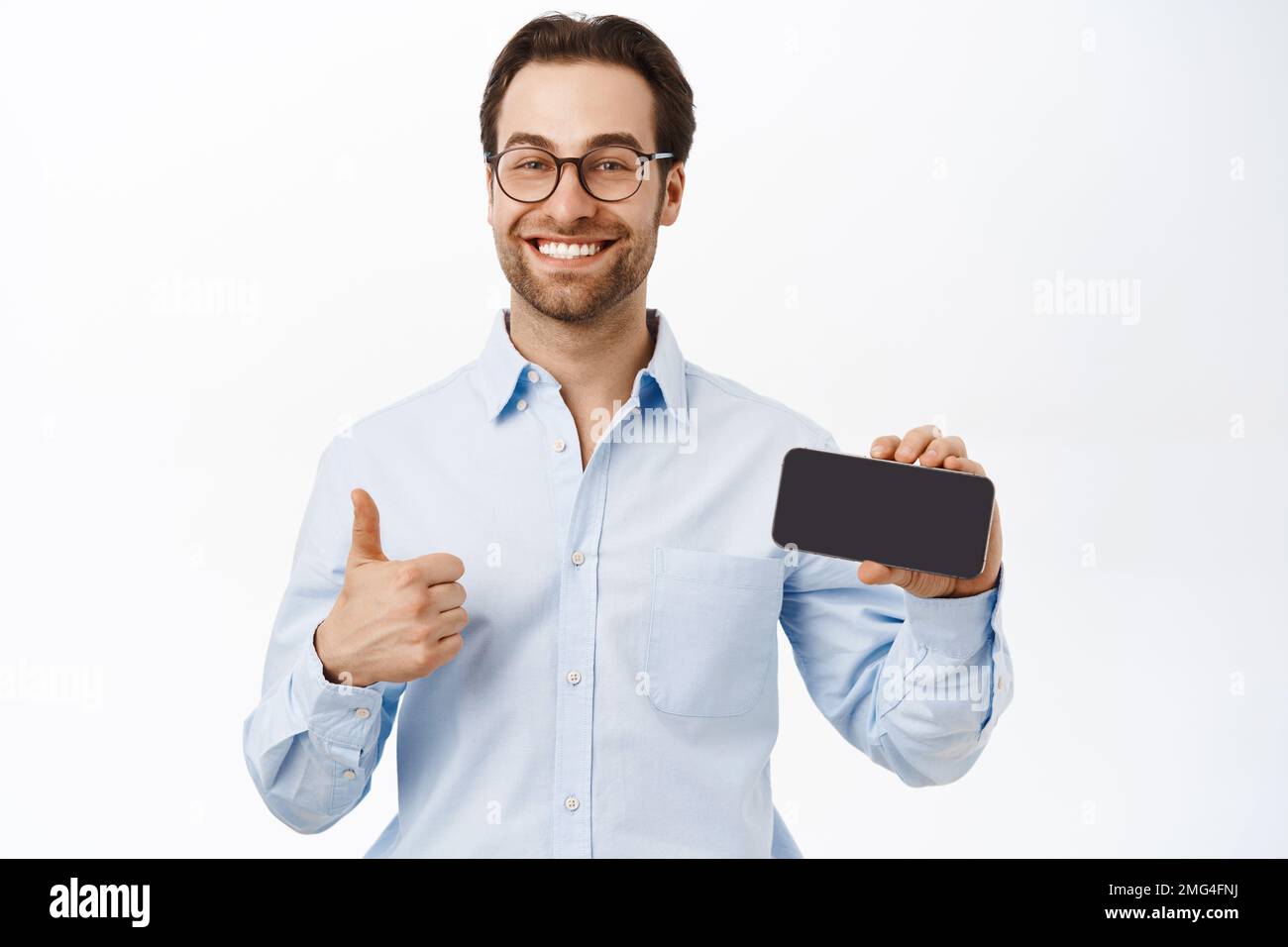 Salesman showing thumbs up with mobile hi-res stock photography and ...