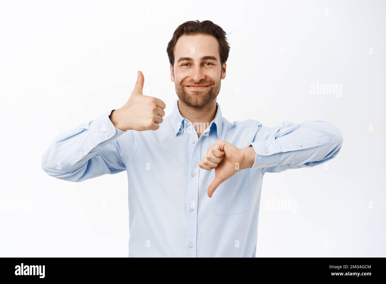 Good or bad. Male entrepreneur shows thumbs up and thumbs down, like ...