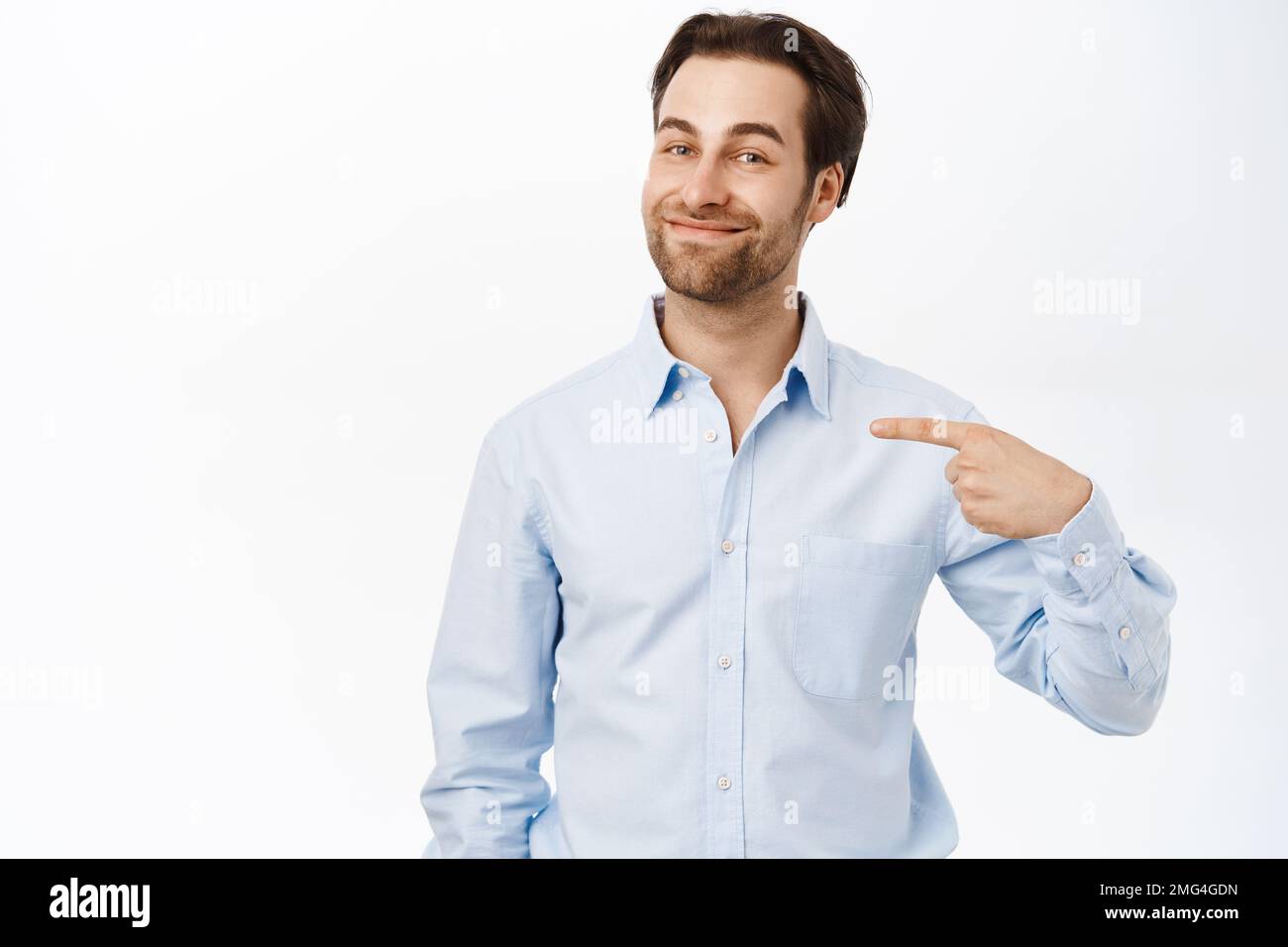 Handsome smiling business man pointing at himself with pleased face ...
