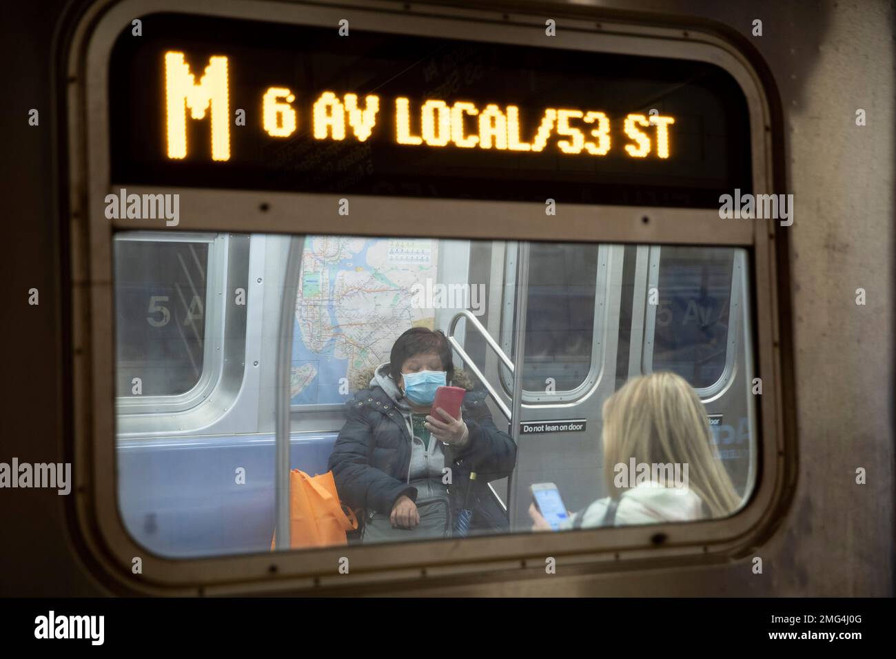 FILE- In this March 19, 2020 file photo, a commuter wears a face mask ...
