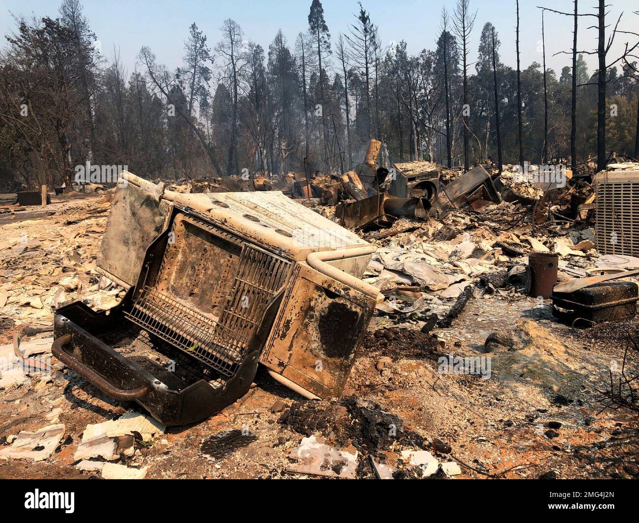 The ruins of homes destroyed by a wildfire litters the ground in ...