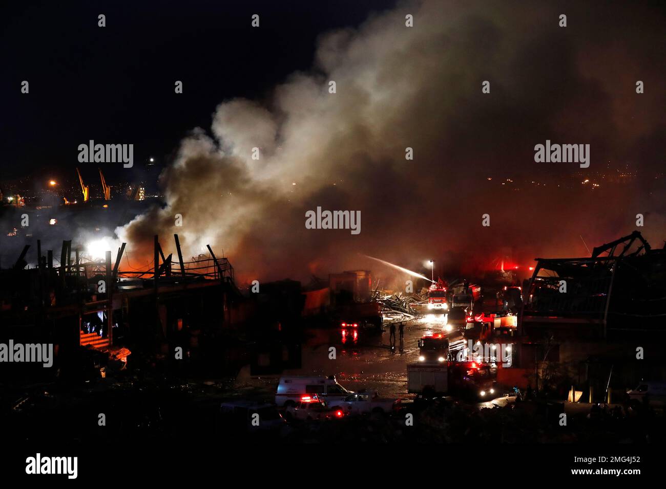 Firefighters extinguish a fire in warehouses at the seaport of Beirut ...