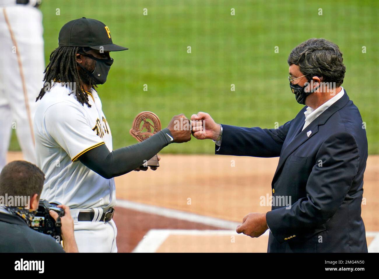 Pittsburgh Pirates' Josh Bell, left, receives his Roberto Clemente ...