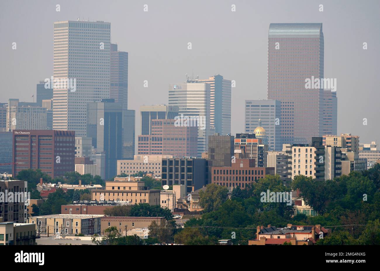 Smoke envelopes the downtown skyline as winds carry the smoky air from the Cameron Peaks ...