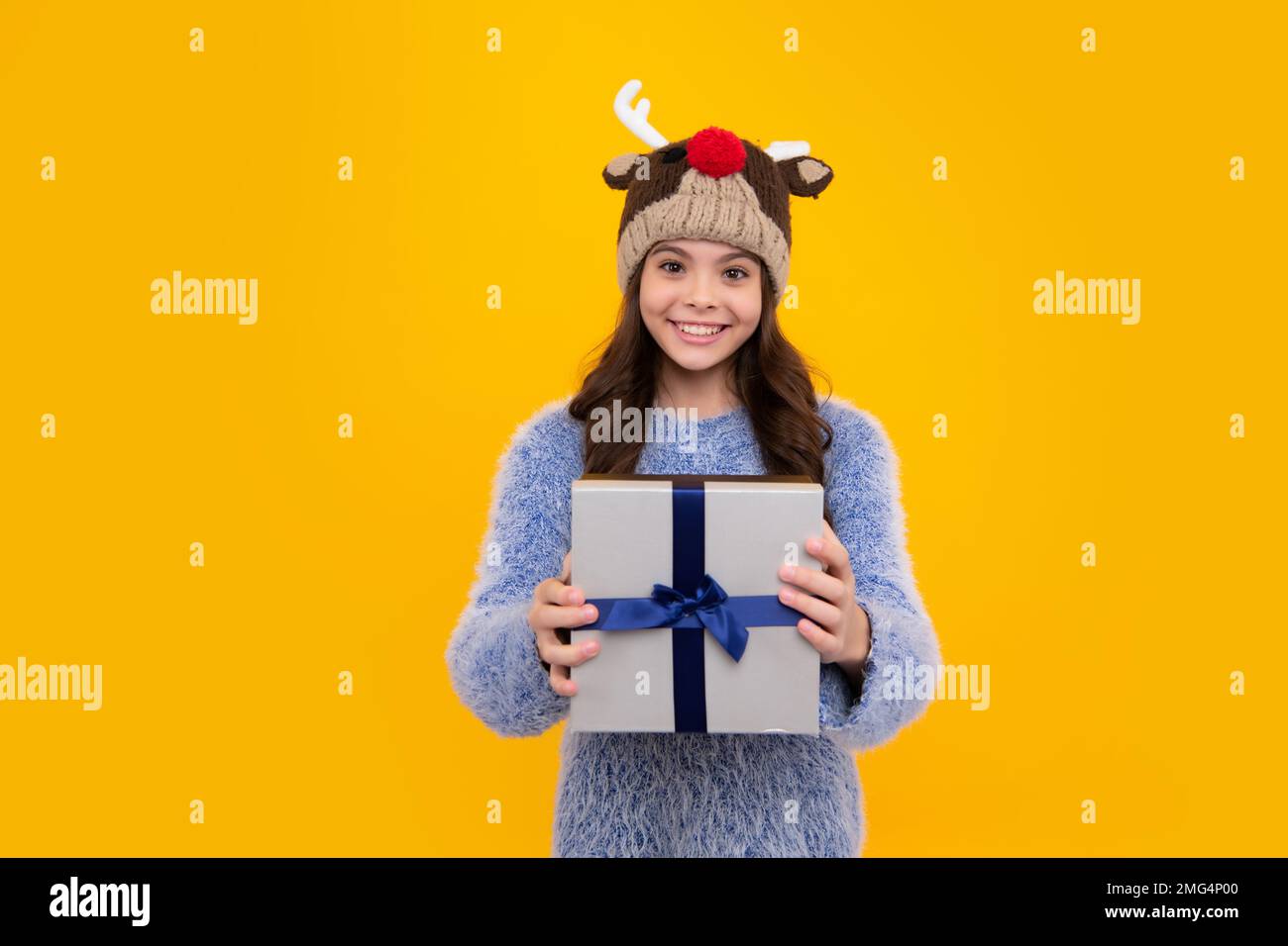 Teenager child in winter wear holding gift boxes celebrating happy New ...