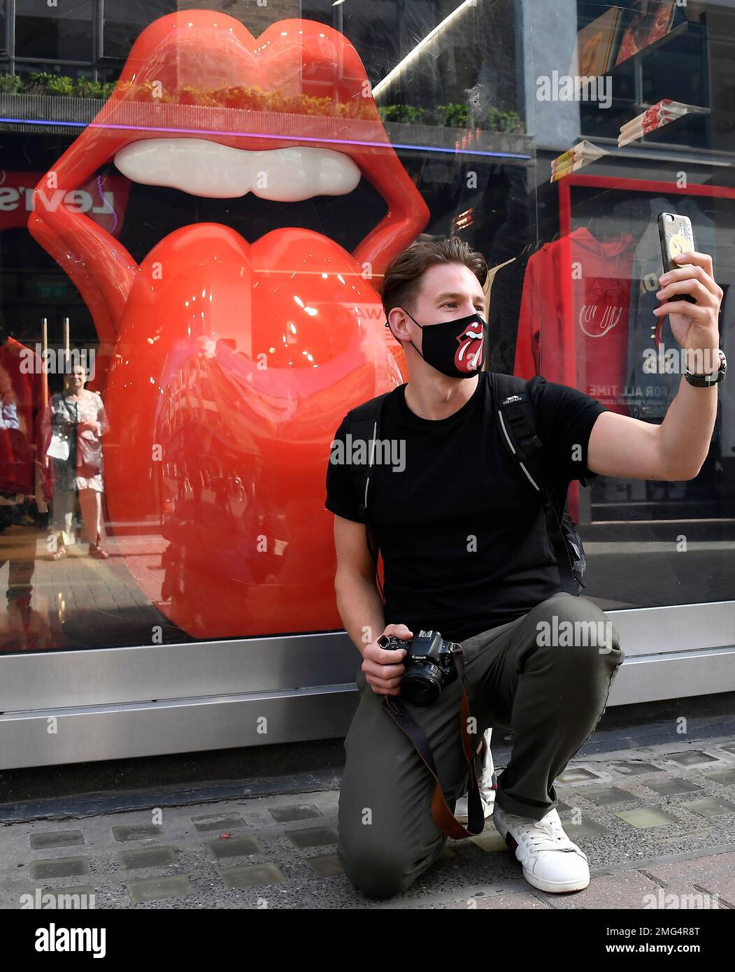 A Rolling Stone fan takes a selfie in front of the new Rolling Stones ...