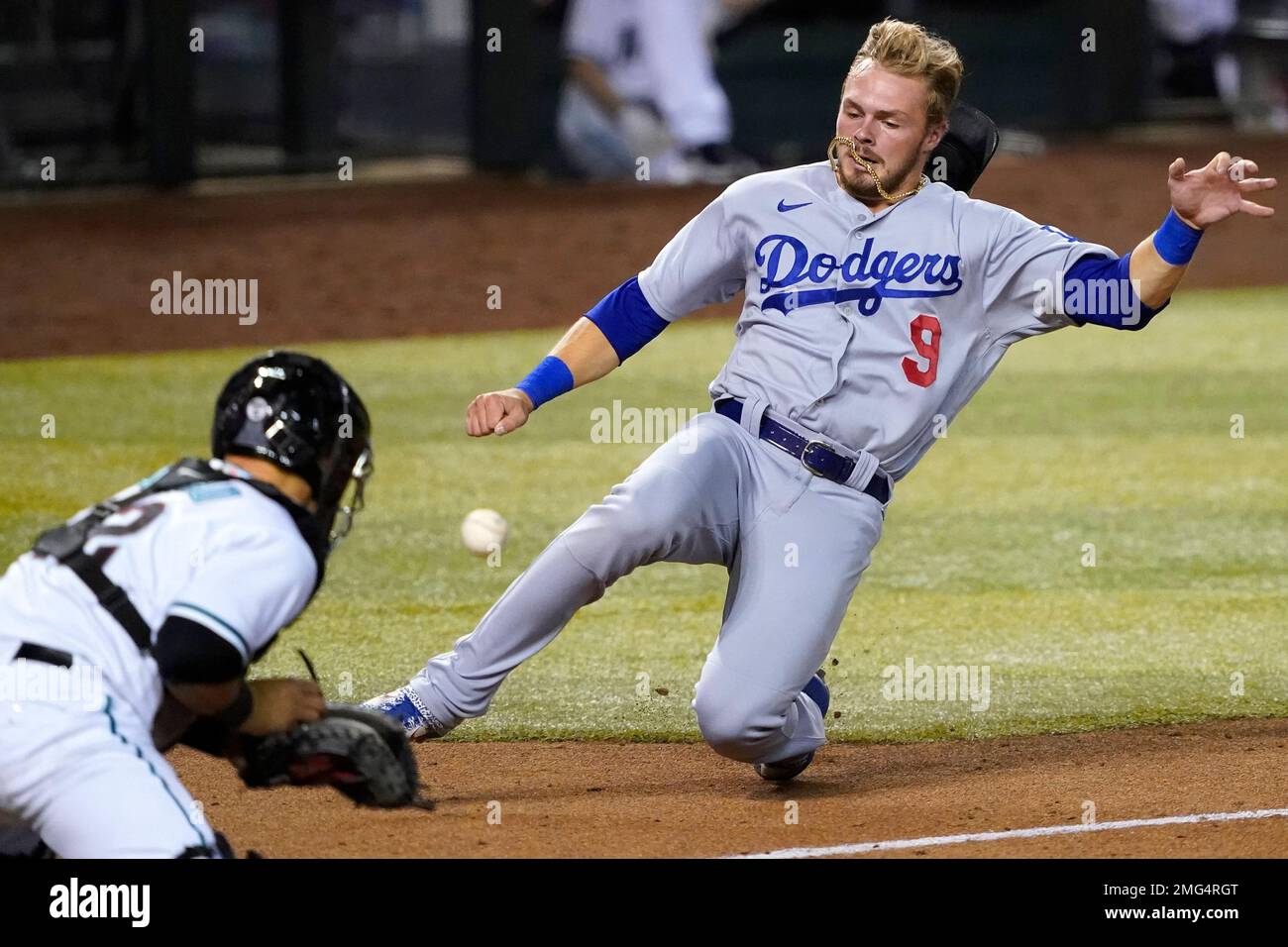 Los Angeles Dodgers' Gavin Lux (9) scores on a base hit by teammate ...