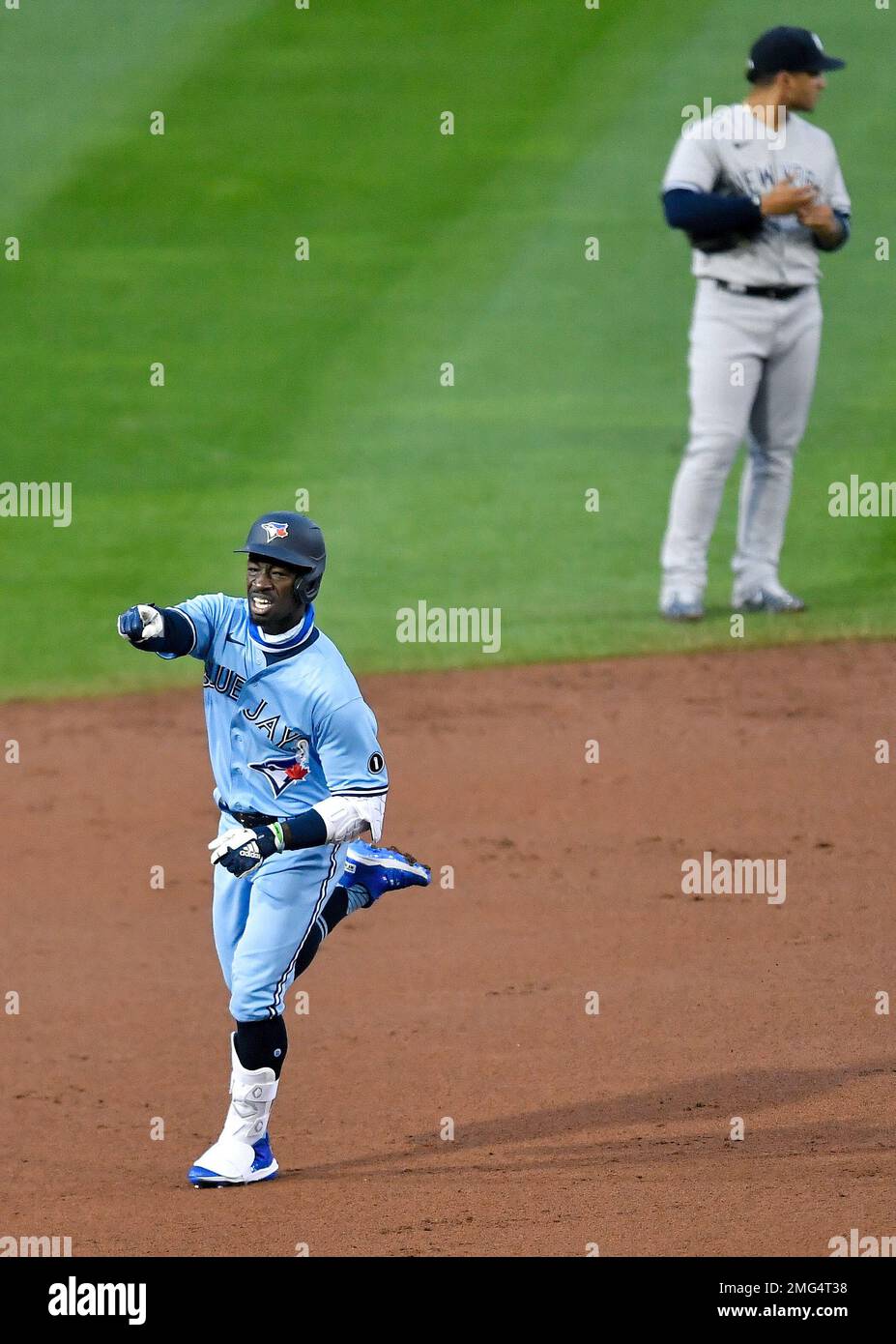 Toronto Blue Jays' Jonathan Davis points to the dugout as he runs the ...