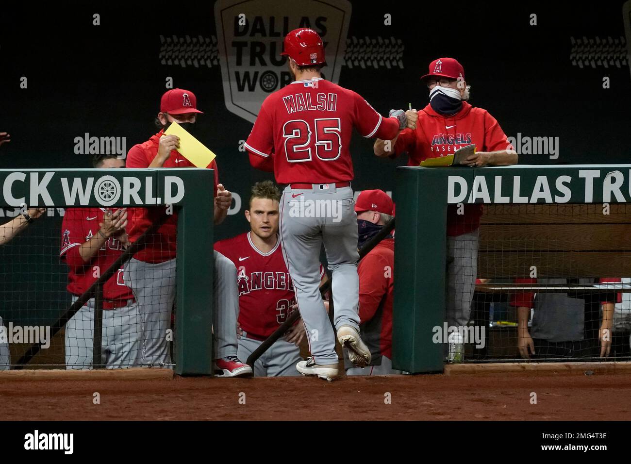 Los Angeles Angels' Jared Walsh is congratulated by manager Joe Maddon ...
