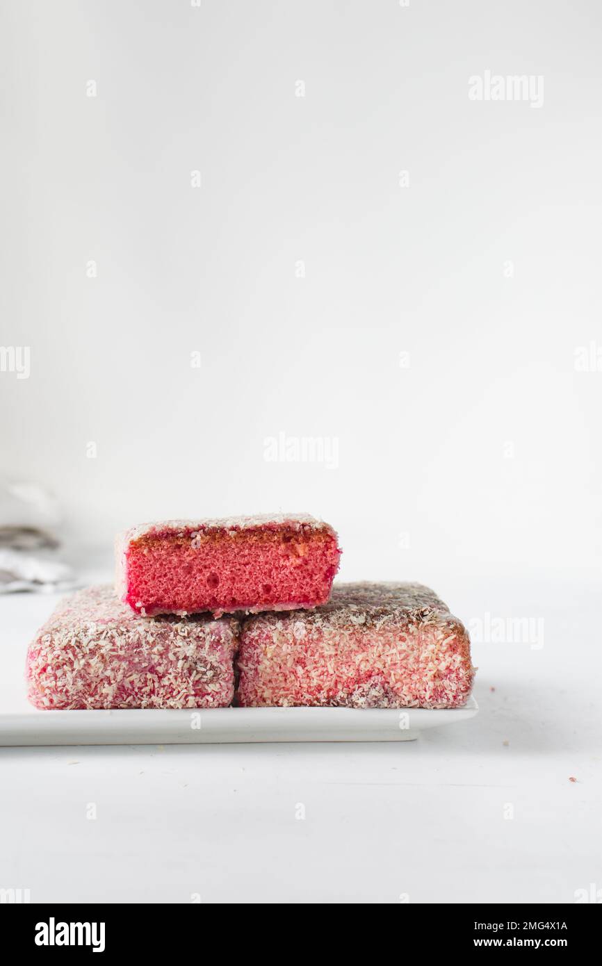 Pink lamingtons on a white background, Australian raspberry lamingtons ...