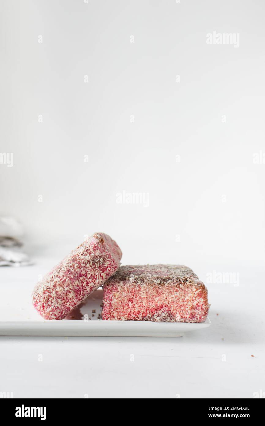 Pink lamingtons on a white background, Australian raspberry lamingtons ...
