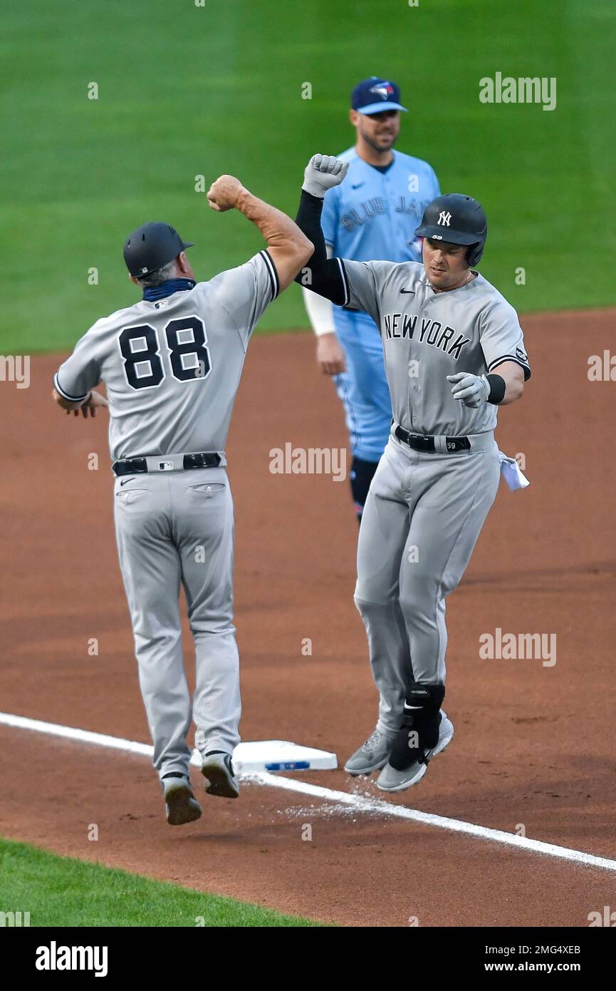 New York Yankees' Luke Voit, right, celebrates with third base coach ...