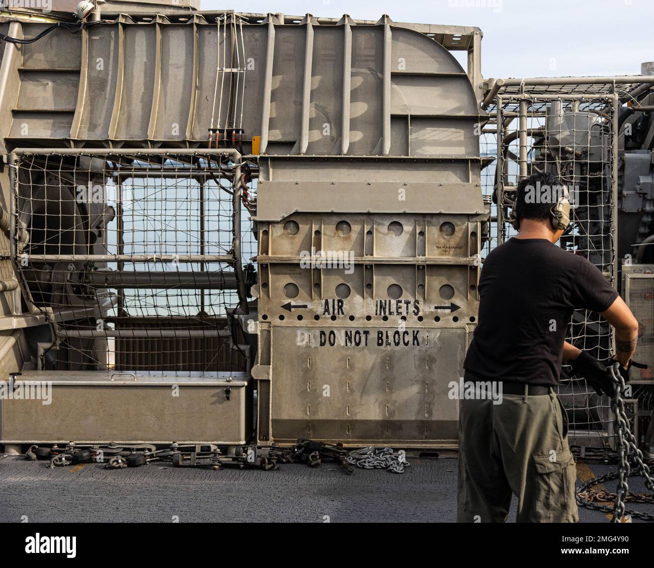 A U.S. Navy Sailor assigned to USS New Orleans (LPD 18), tightens a ...