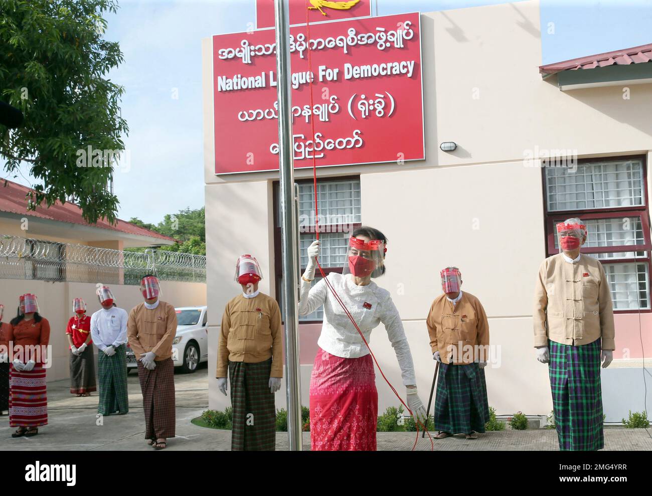 Myanmar leader Aung San Suu Kyi raises the flag of the National League ...