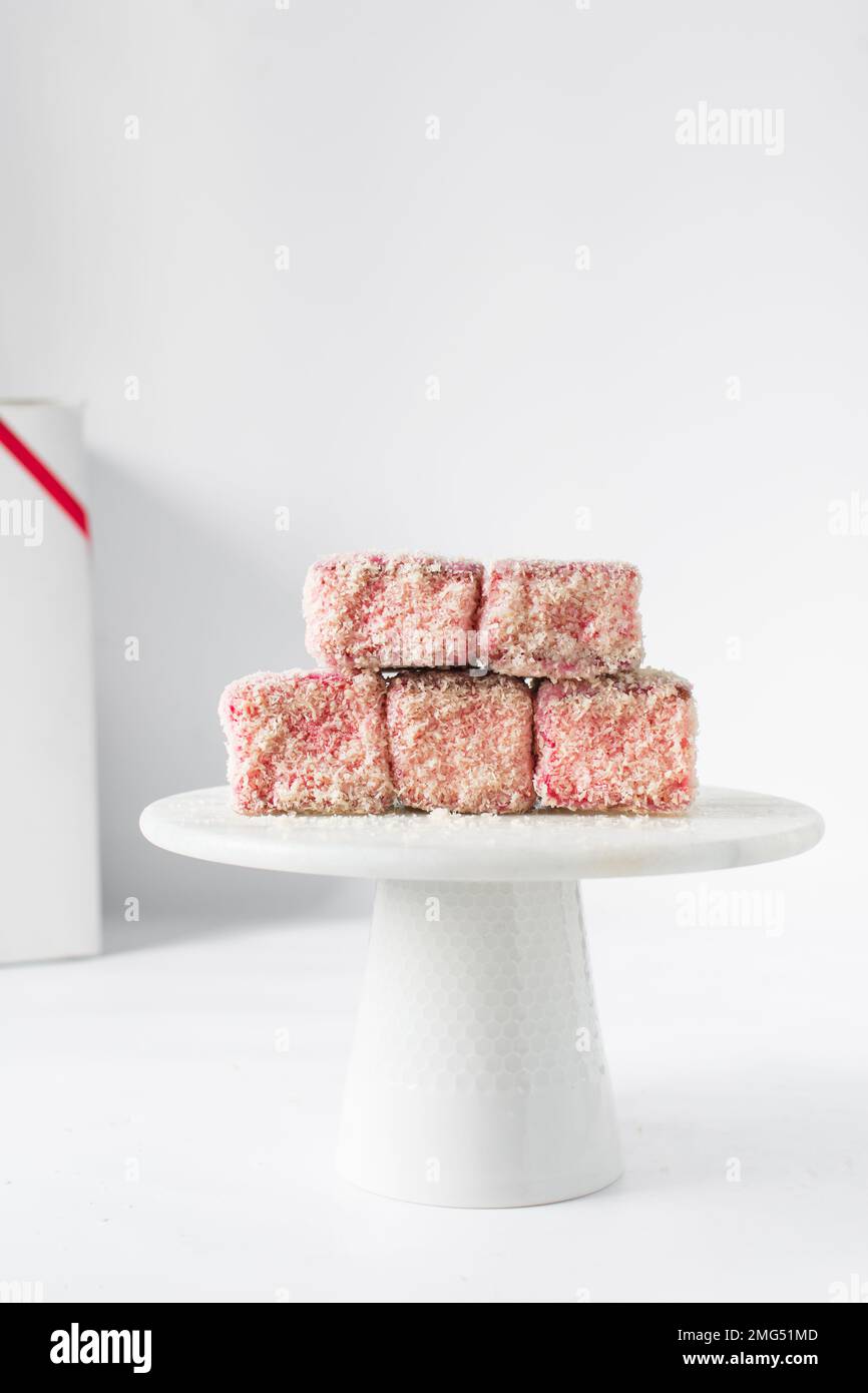 Pink lamingtons on a white marble cake stand Australian raspberry ...