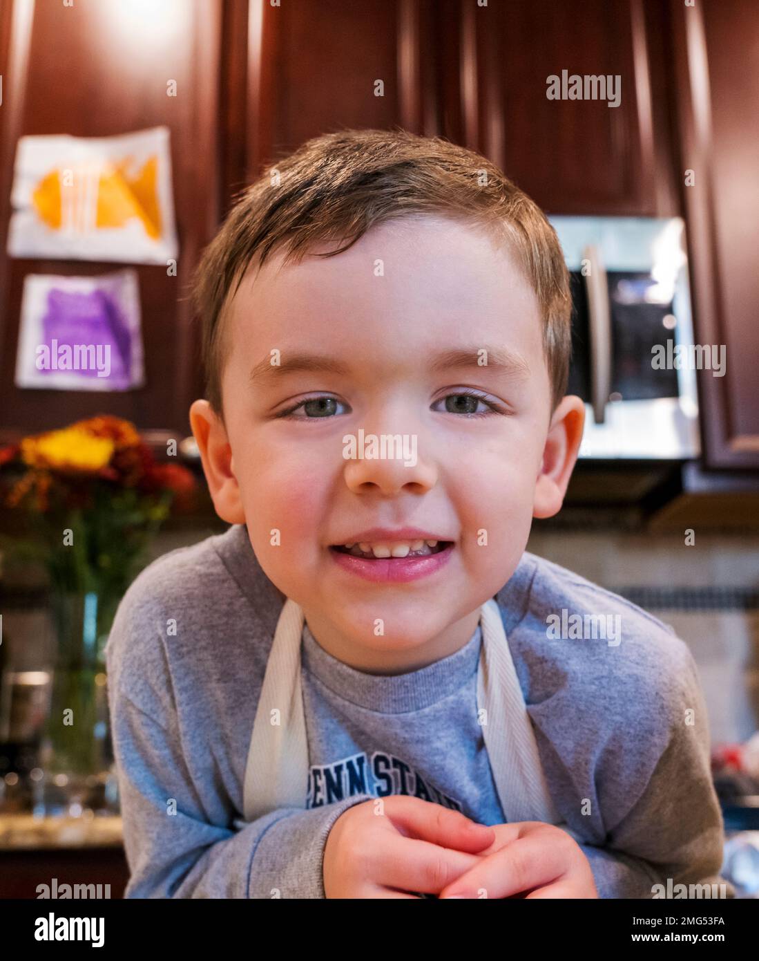 Photograph of 3 year old boy helping in the kitchen Stock Photo - Alamy