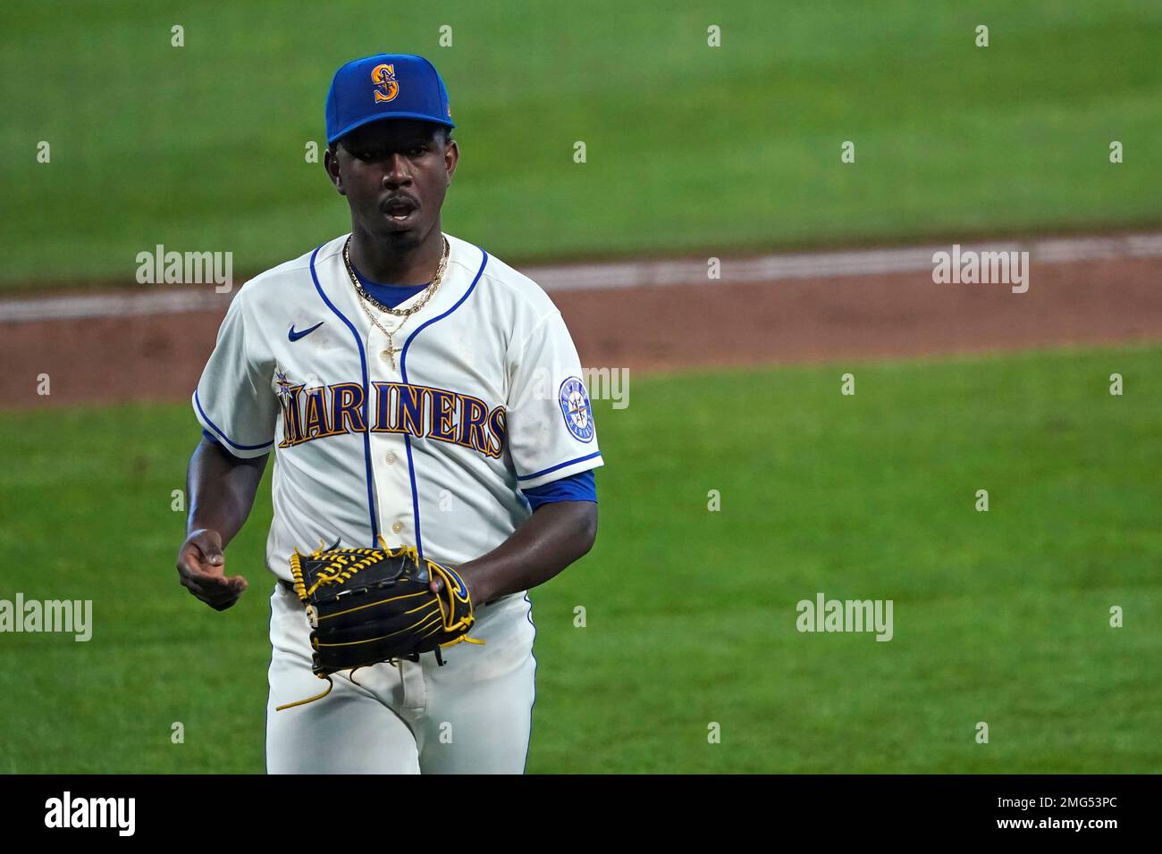 Seattle Mariners starting pitcher Justin Dunn walks off the field after ...
