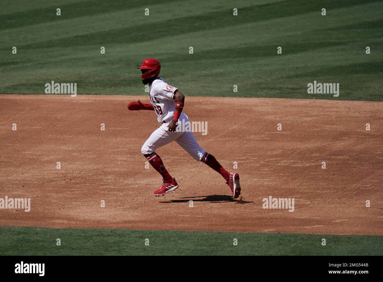Los Angeles Angels' Jo Adell runs to third base on a wild pitch by ...