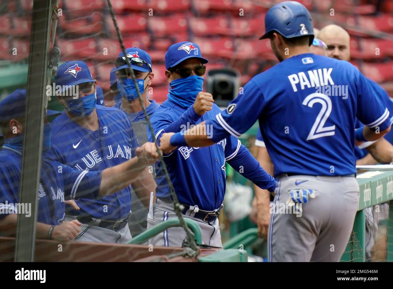 Toronto Blue Jays' Joe Panik (2) is welcomed to the dugout after ...