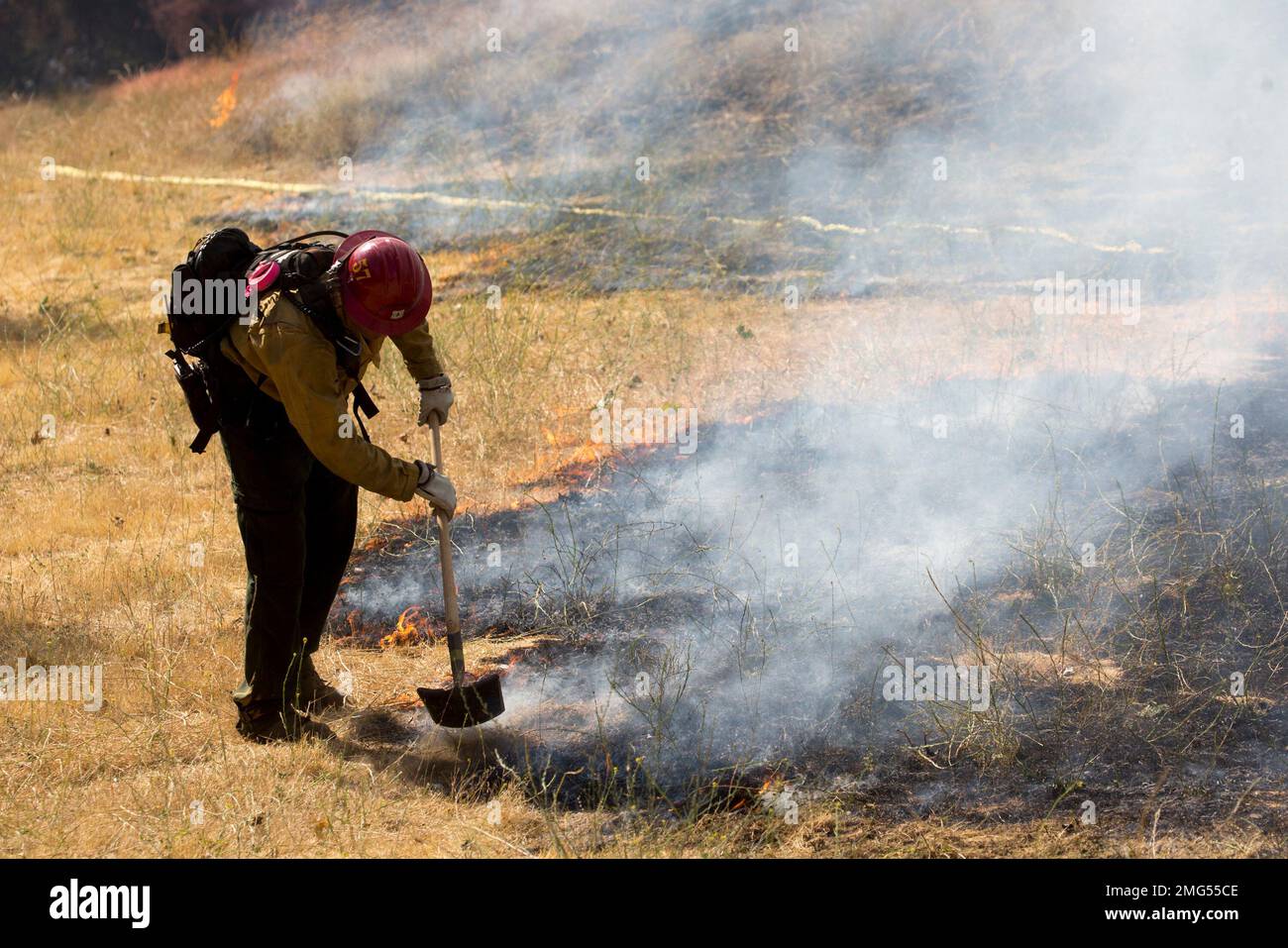 A member of hand crew works on the fire line in Yucaipa, Calif ...