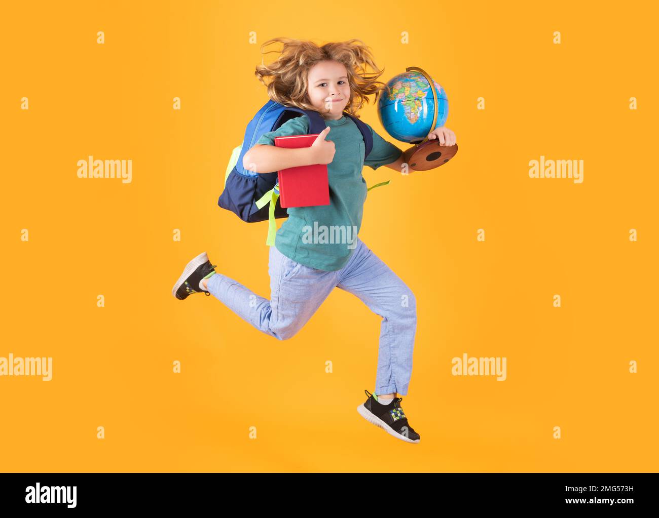 Shool kid jump with school bag and globe. School boy in school uniform ...