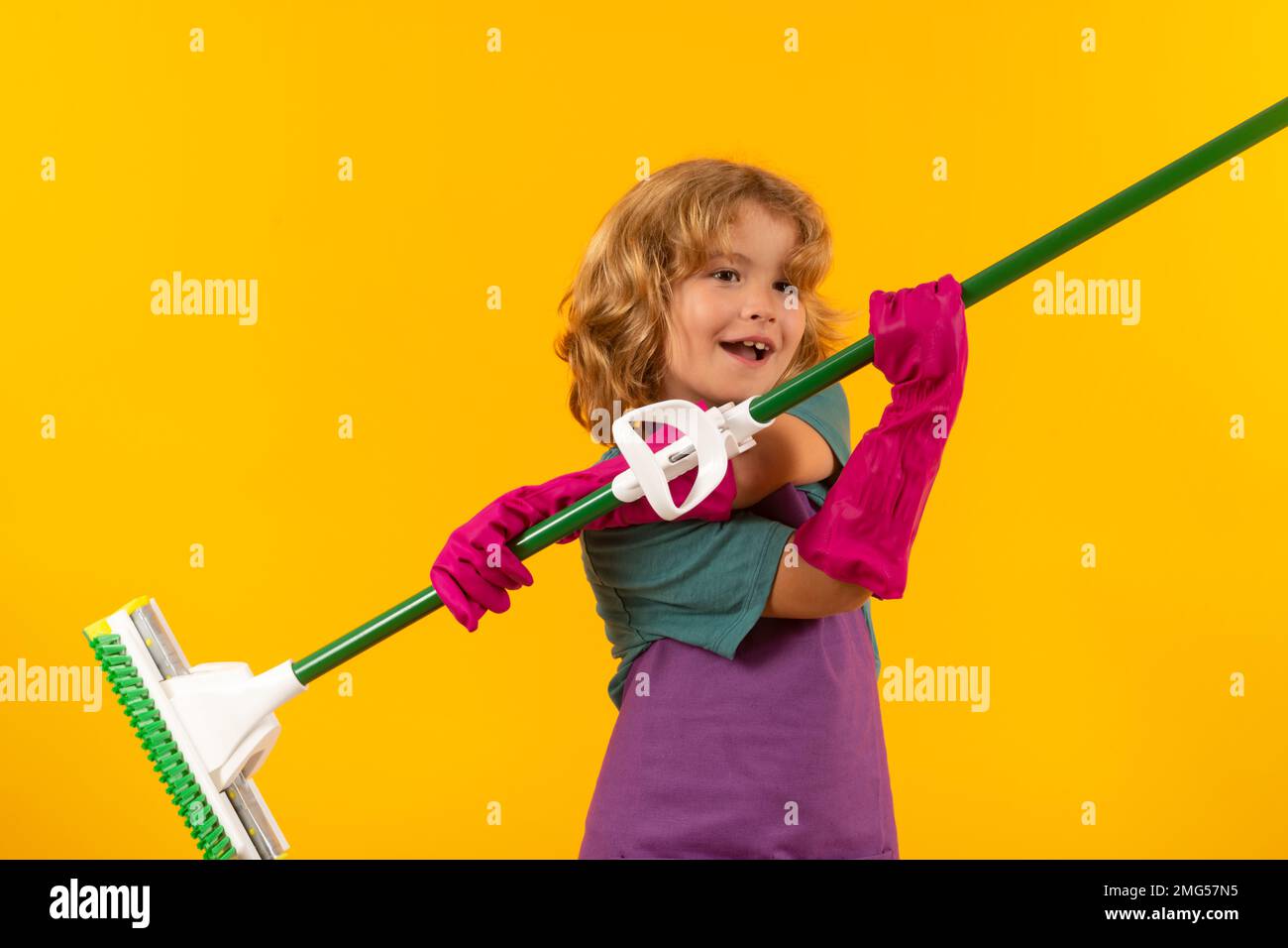Cleaning house. Studio isolated portrait of child mopping house ...