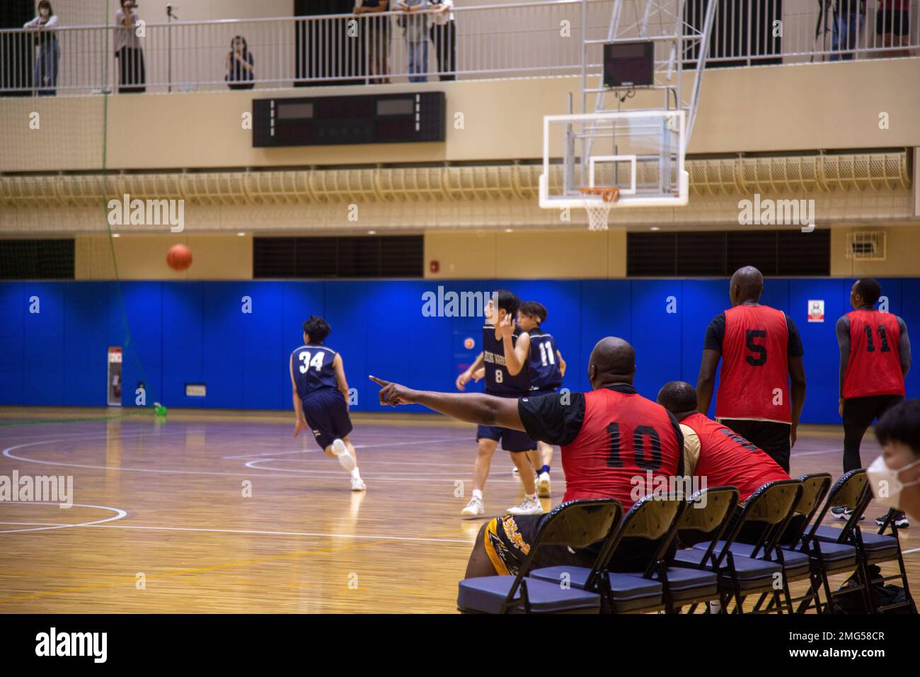 A member of the Branch Health Clinic Medical basketball team coaches ...