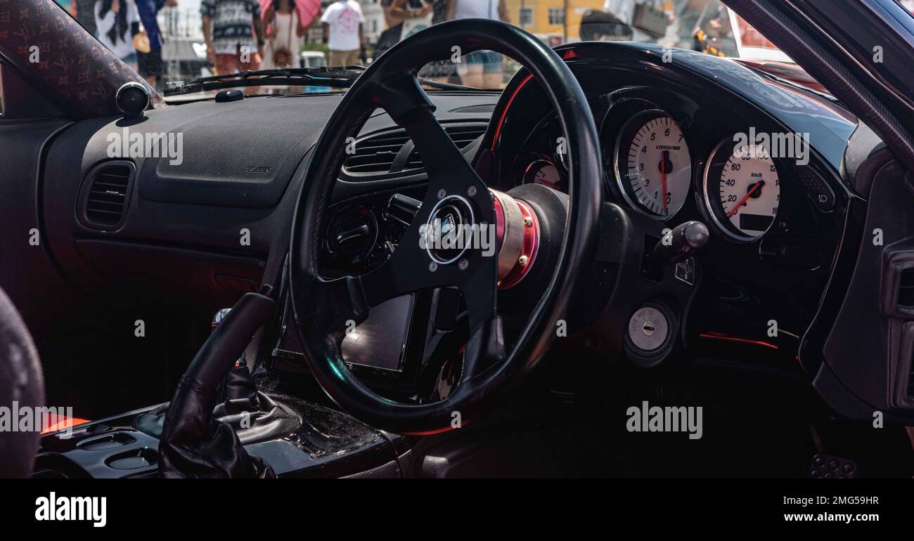 A Veilside RX7 steering wheel is displayed during a food truck fair and ...