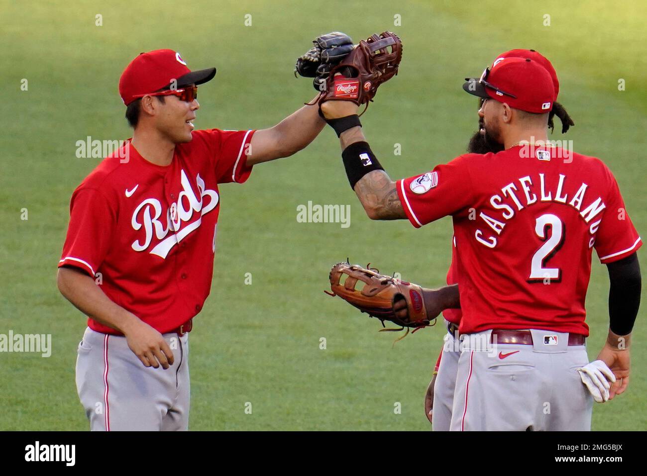 Cincinnati Reds outfielders Shogo Akiyama, left, Nick Castellanos (2 ...