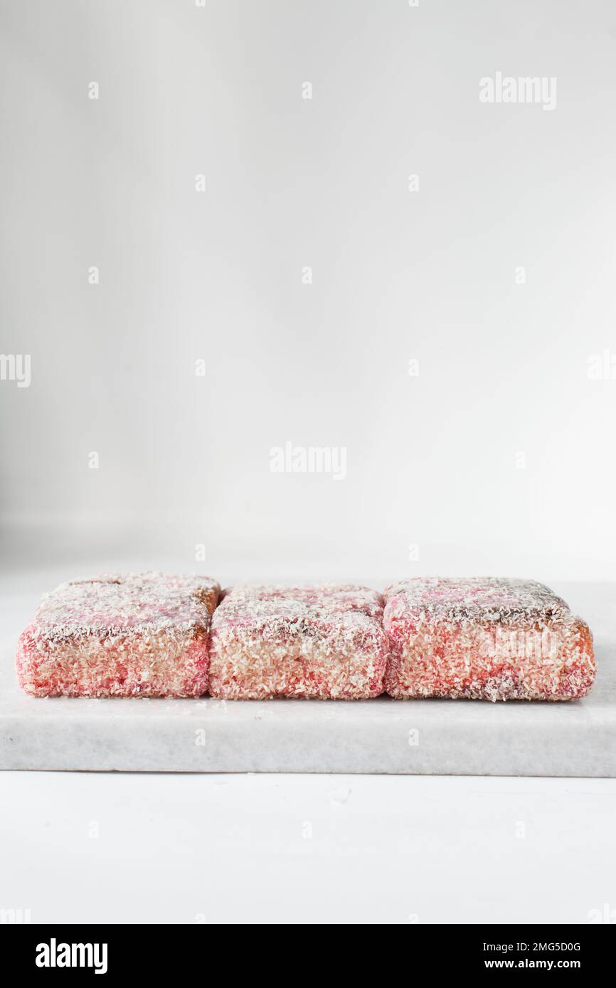 Pink lamingtons on a marble tray, Australian raspberry lamingtons, cake ...