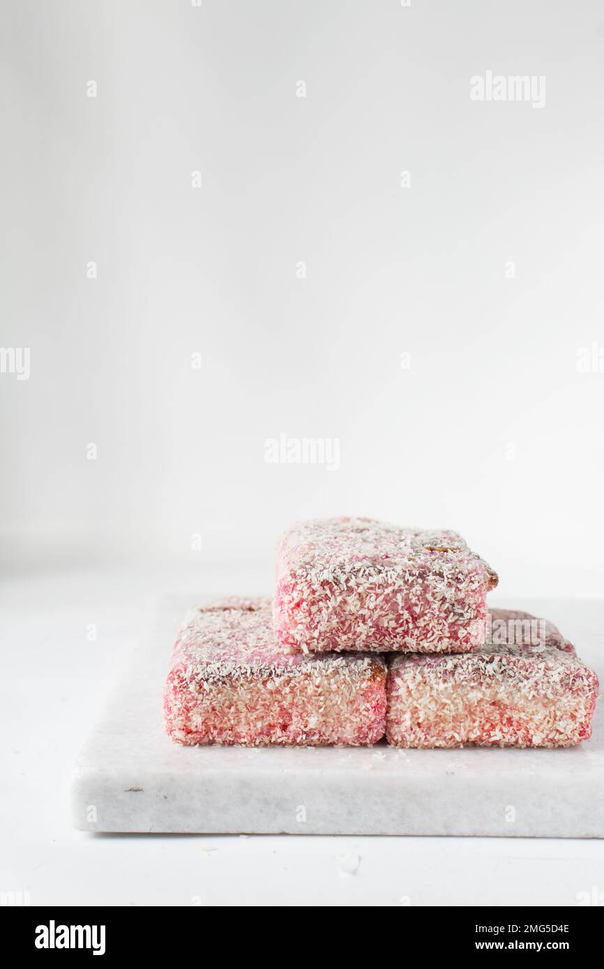 Pink lamingtons on a marble tray, Australian raspberry lamingtons, cake ...