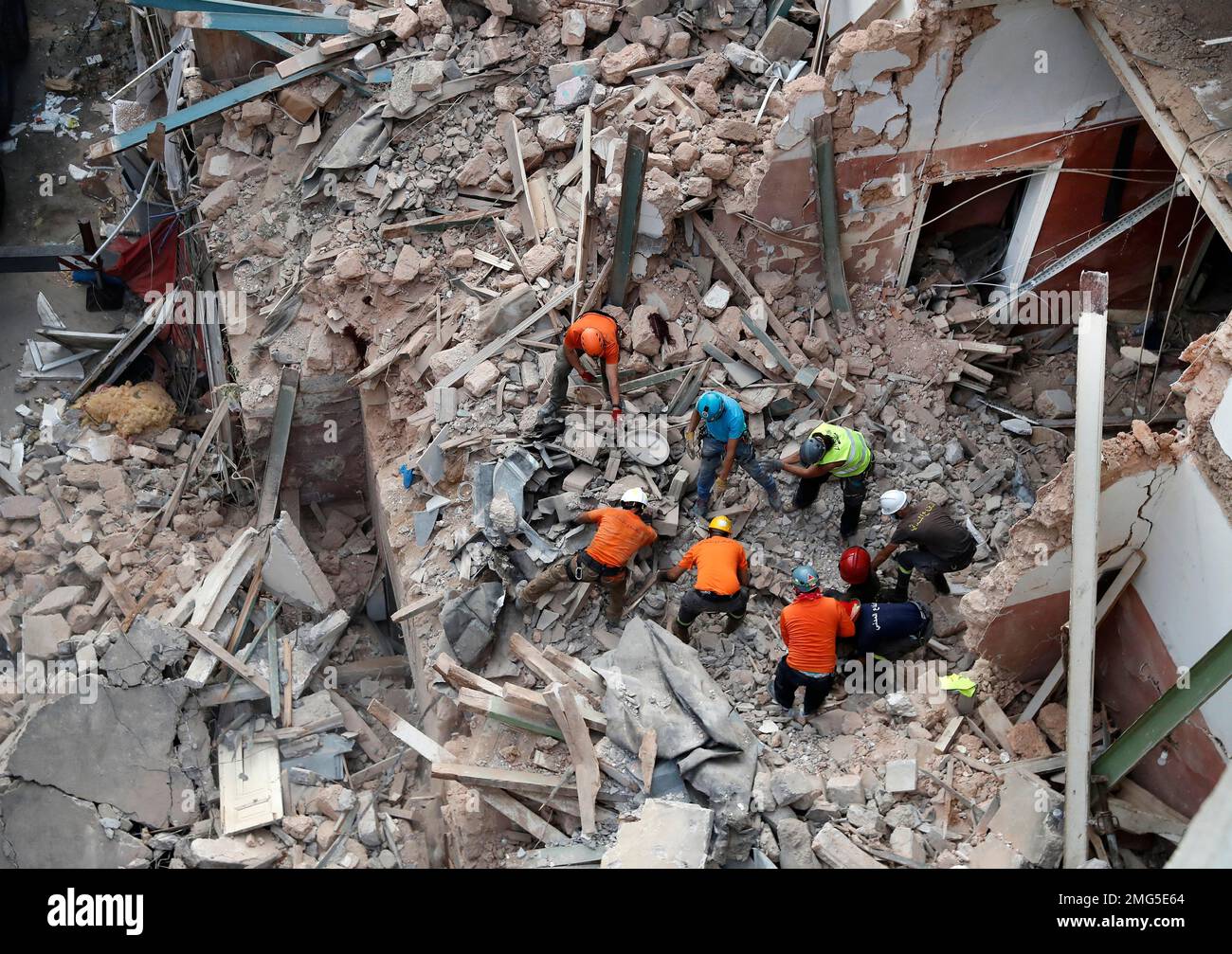 Lebanese and Chilean rescuers search in the rubble of a collapsed ...