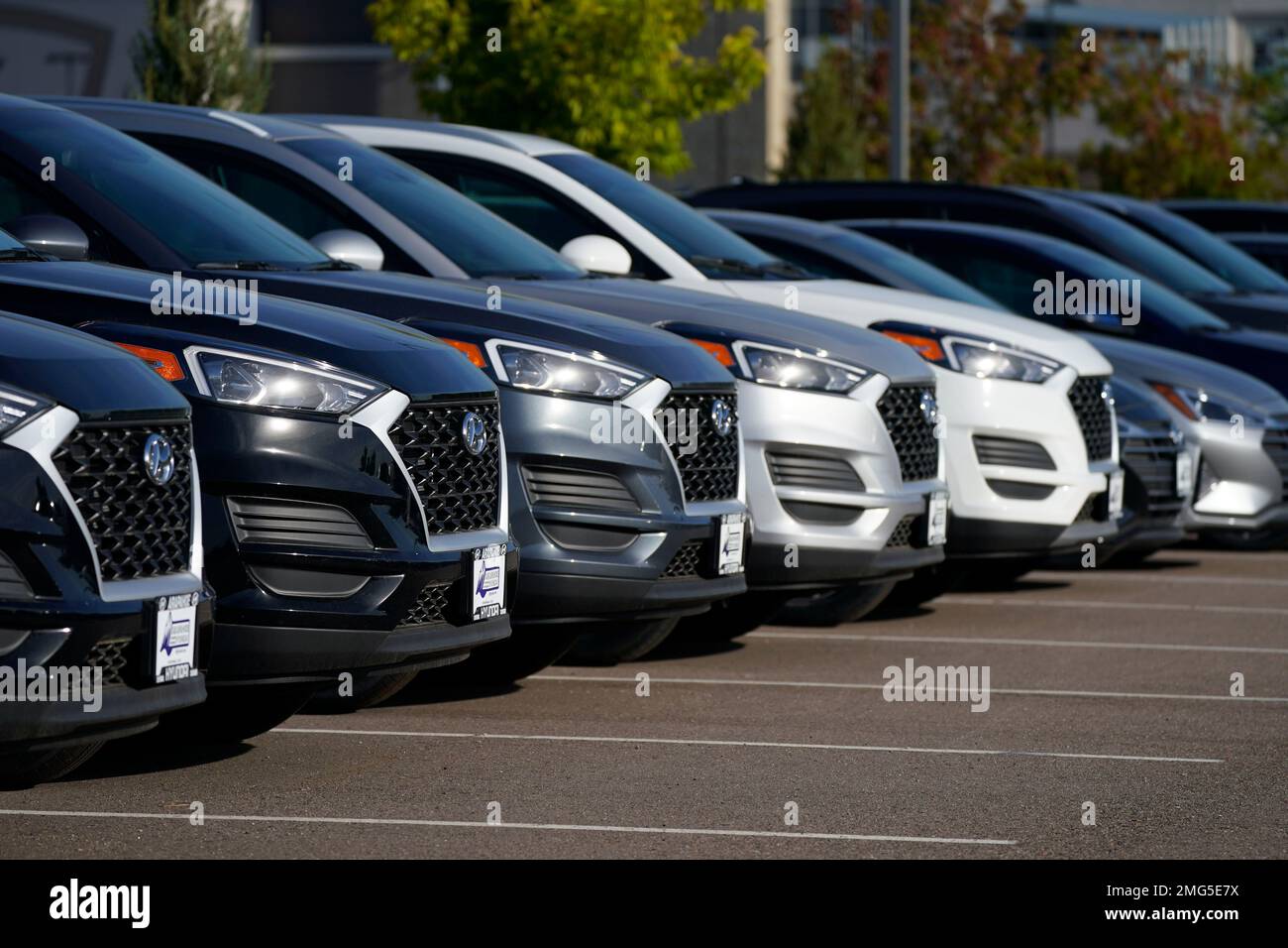 A long line of unsold 2020 Hyundai models sits in a storage lot ...