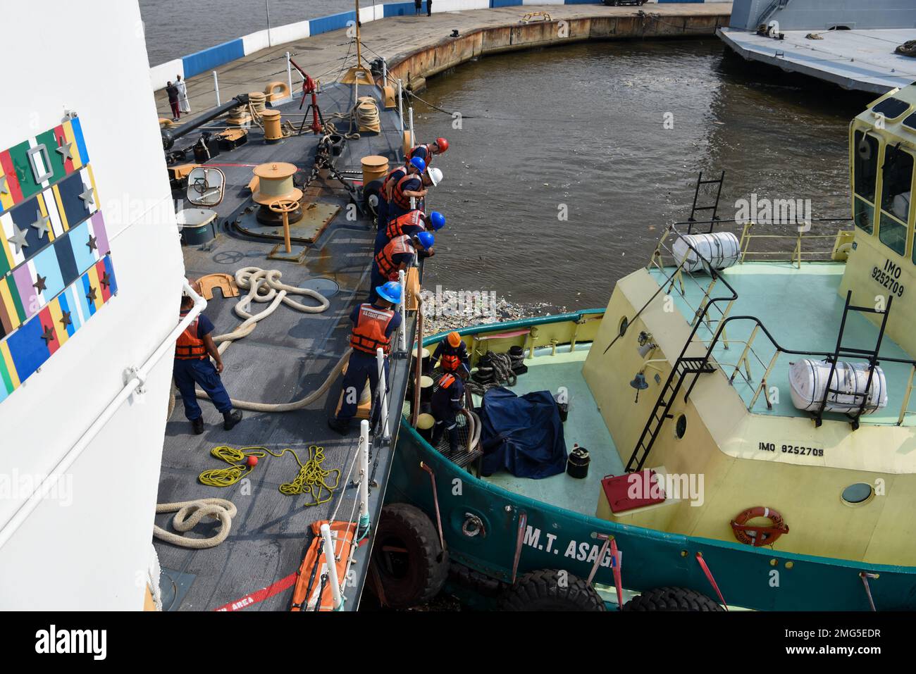 Crew members assigned to USCGC Mohawk (WMEC 913) throw over lines to a ...