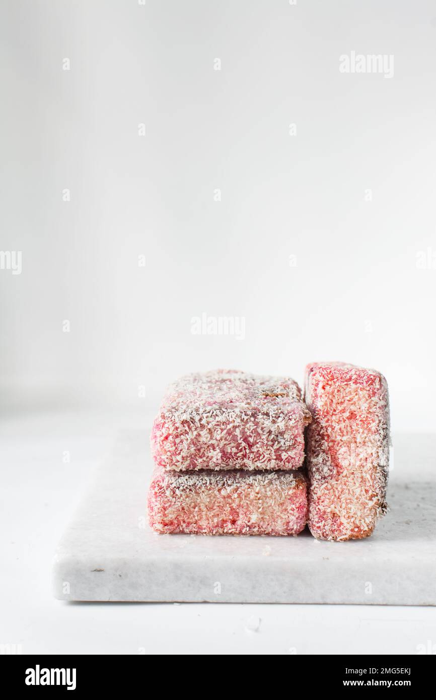 Pink lamingtons on a marble tray, Australian raspberry lamingtons, cake ...
