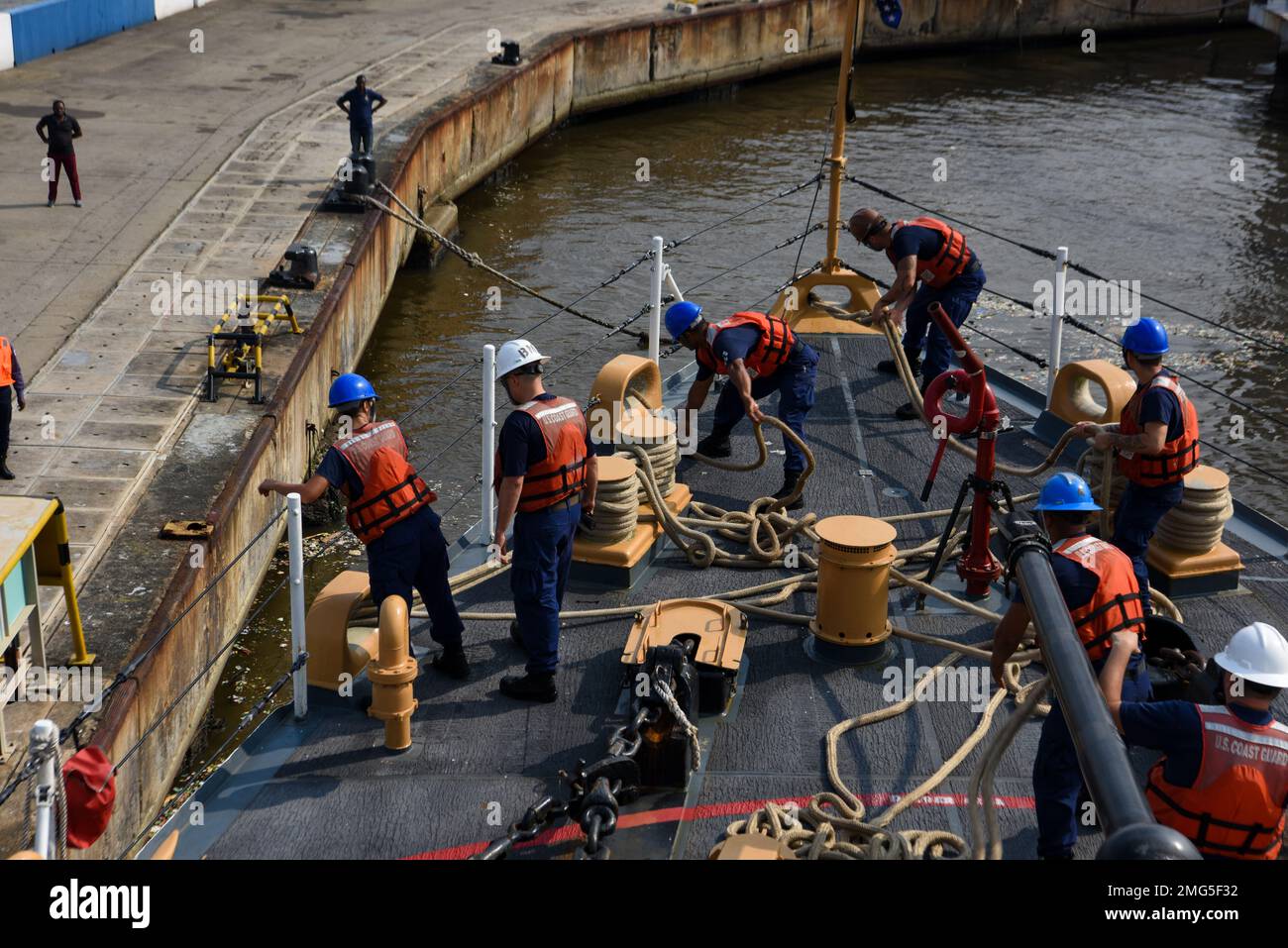 Crew members assigned to USCGC Mohawk (WMEC 913) prepare to depart from ...