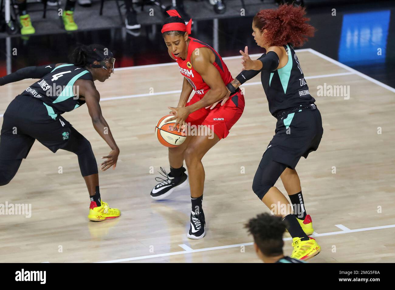 Atlanta Dream's Monique Billings, center, works between New York ...