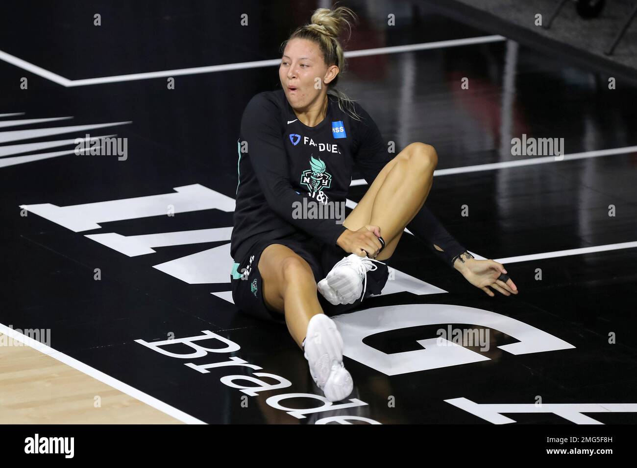 New York Liberty's Kylee Shook holds her leg after an apparent injury ...