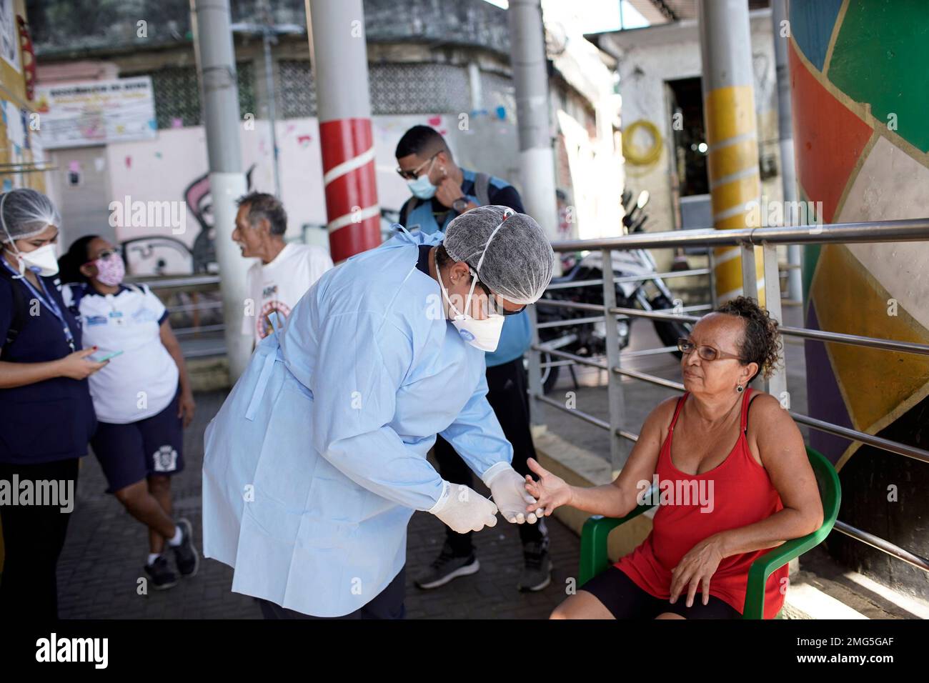 A city health worker takes a resident's blood sample during a city new ...