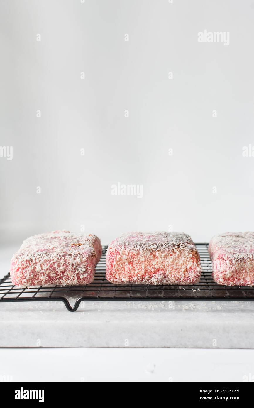 Pink lamingtons on a white background, Australian raspberry lamingtons ...