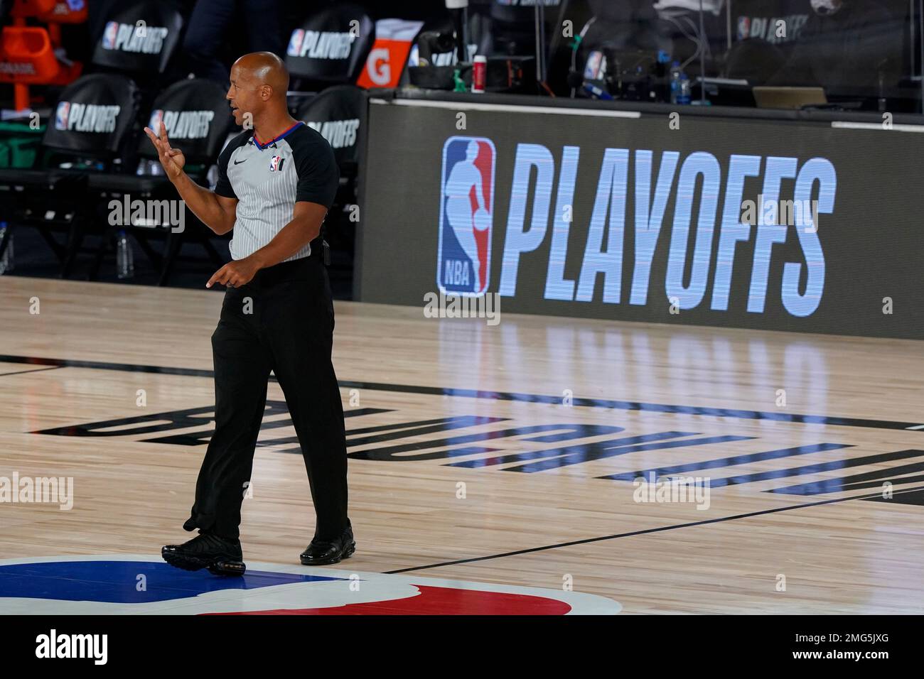 A referee walks on the court during the second half of an NBA ...