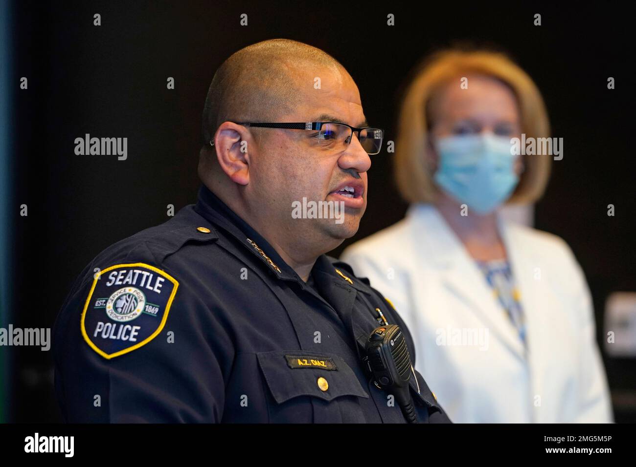 Interim Seattle Police Chief Adrian Diaz, left, addresses a news ...