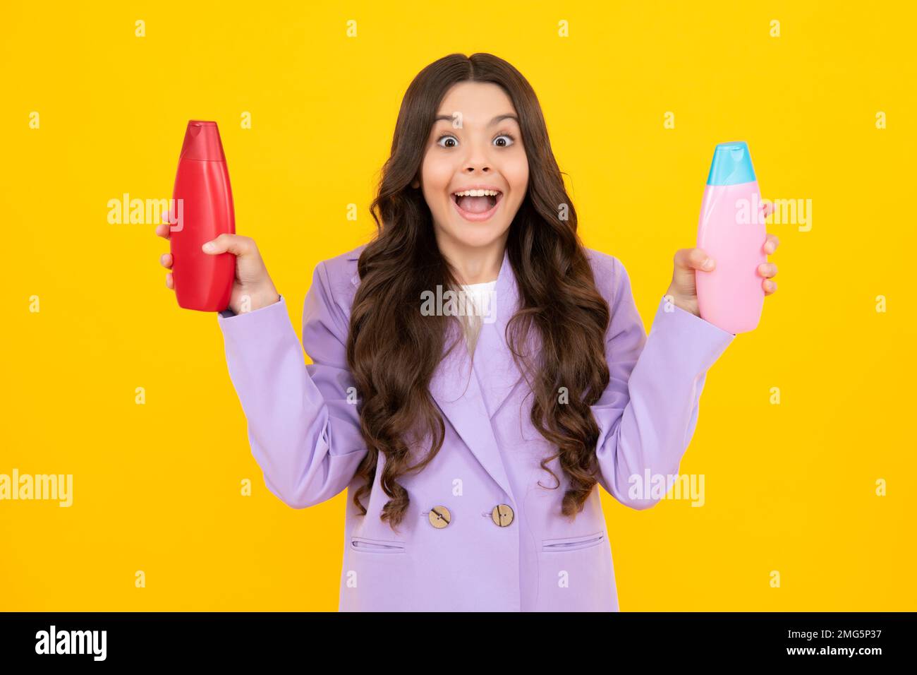 Child teen girl with shampoos conditioners and shower gel. Long hair ...