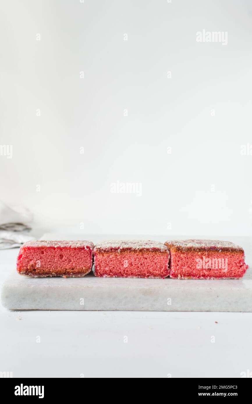 strawberry cakes on a marble tray, pink strawberry cake slices on a ...