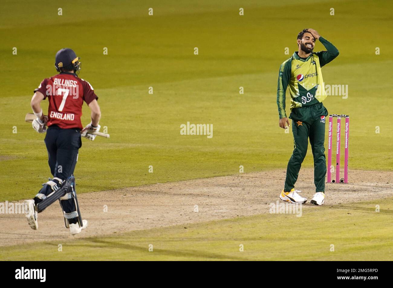 Pakistan's Shadab Khan, right, reacts after a shot played by England's ...